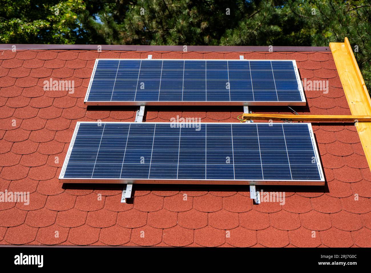 Solar panel on the roof of the house. Red tiles. Photovoltaic panels ...