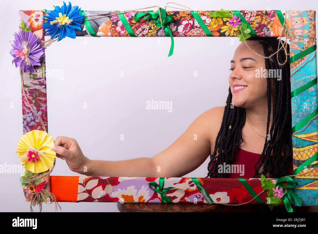 Photo of beautiful woman with braids in her hair behind a frame ...