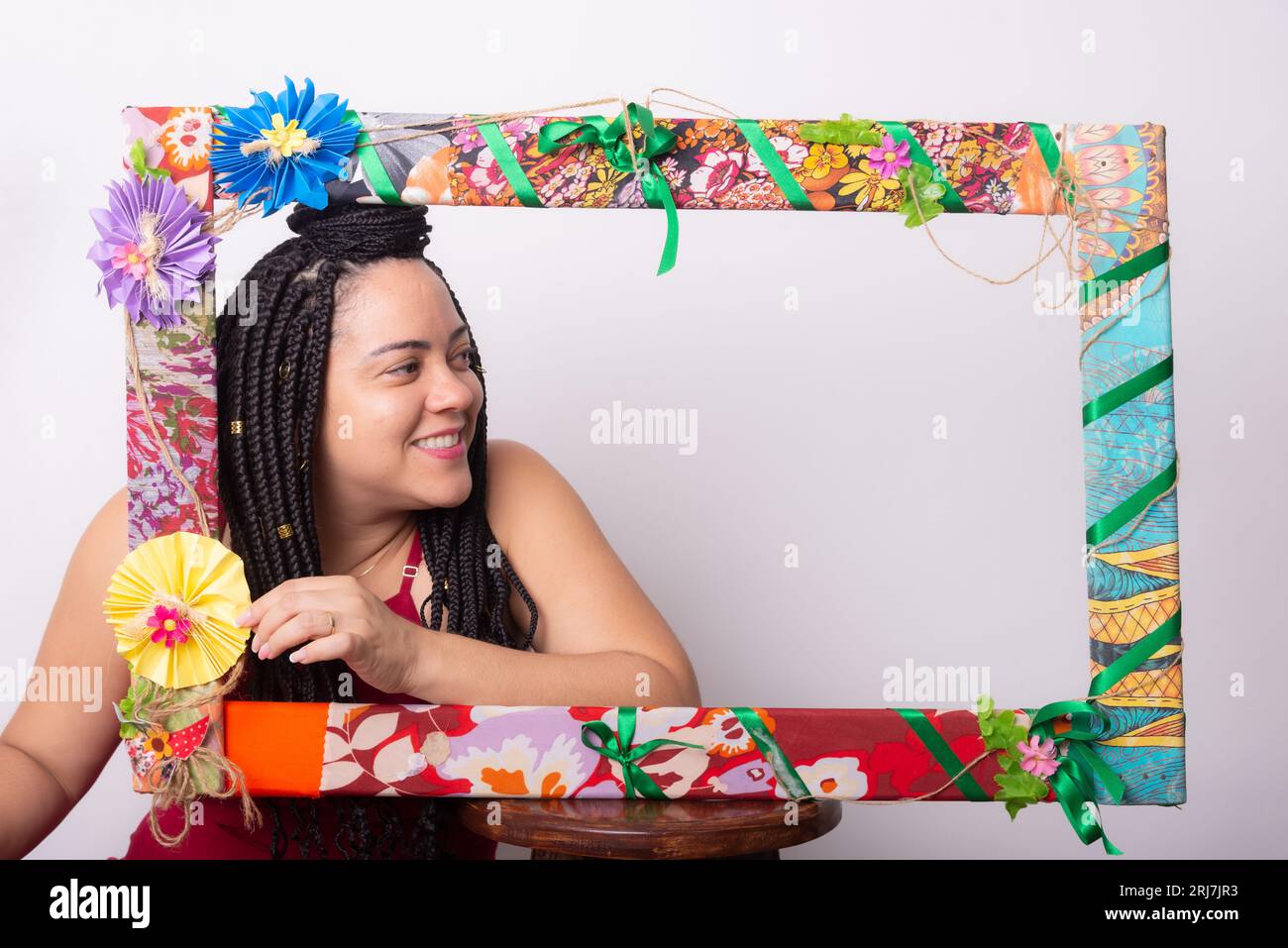 Photo of a beautiful woman with braids in her hair behind a frame ...