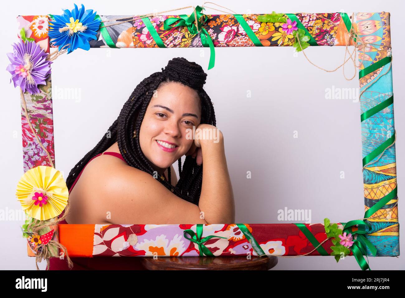 Photo of a beautiful woman with braids in her hair behind a frame ...