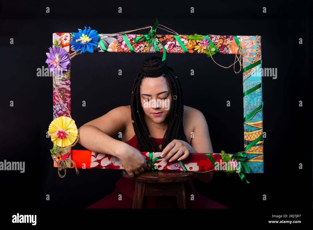 Photo of beautiful woman with braids in her hair inside a frame adorned ...