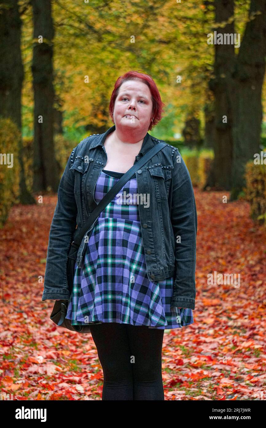 a person standing outside during autumn Stock Photo - Alamy