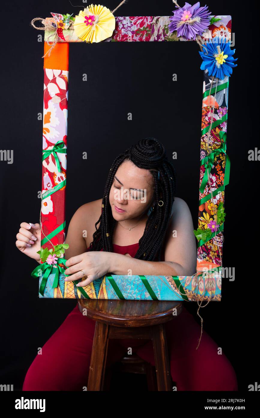 Beautiful woman with braids in her hair inside a frame adorned with ...