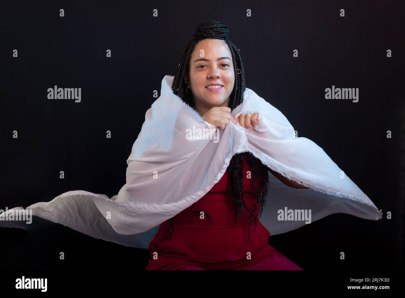 Photo of a beautiful woman with braids in her hair wearing red colored ...