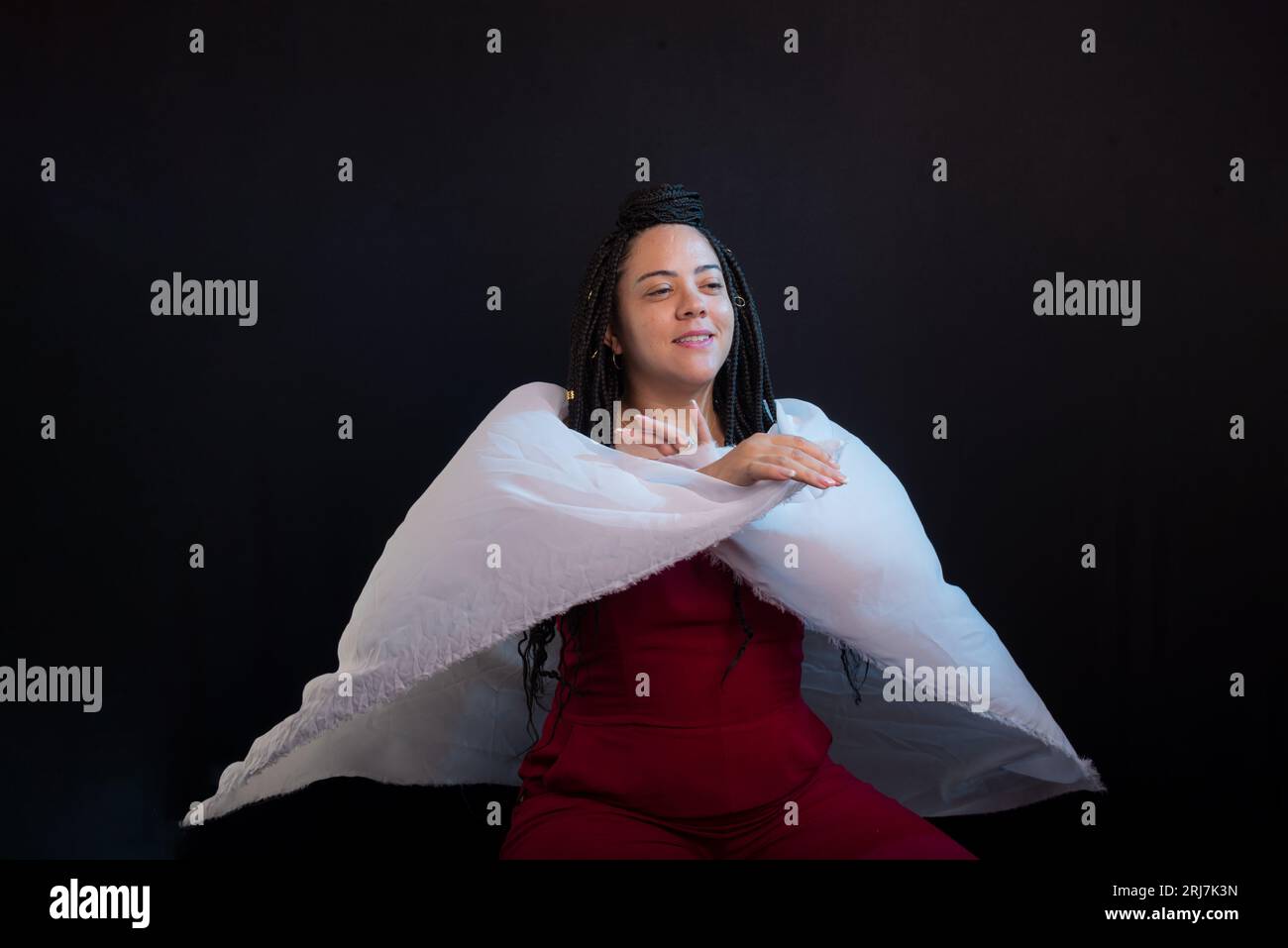 Photo of a beautiful woman with braids in her hair wearing red colored ...