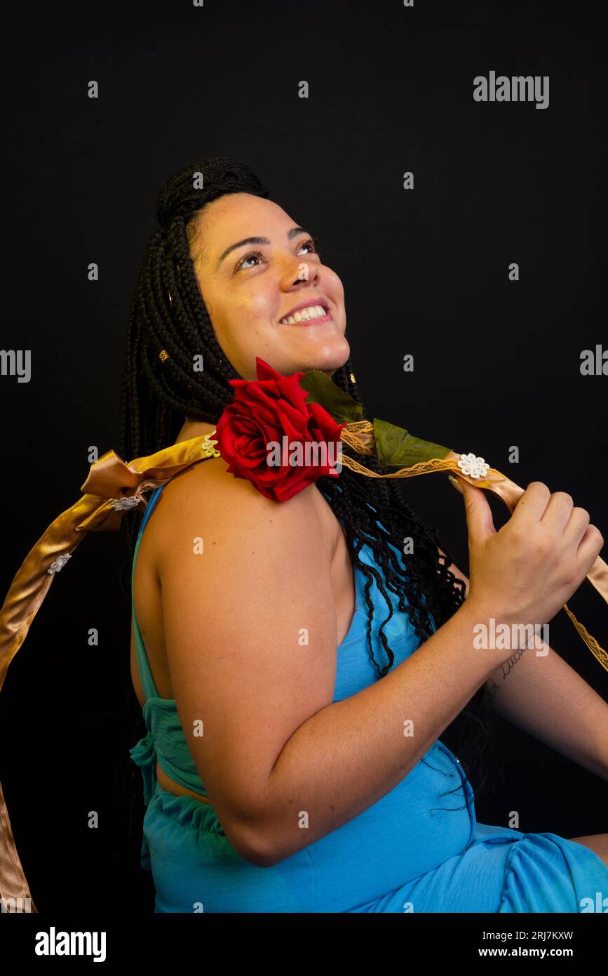 Beautiful woman wearing blue colored outfit sitting holding a hula hoop ...
