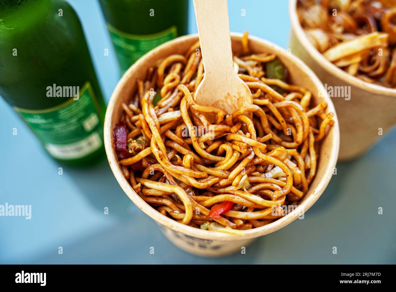 Chinese takeaway food. Wok with noodles and bottles with cold beer ...
