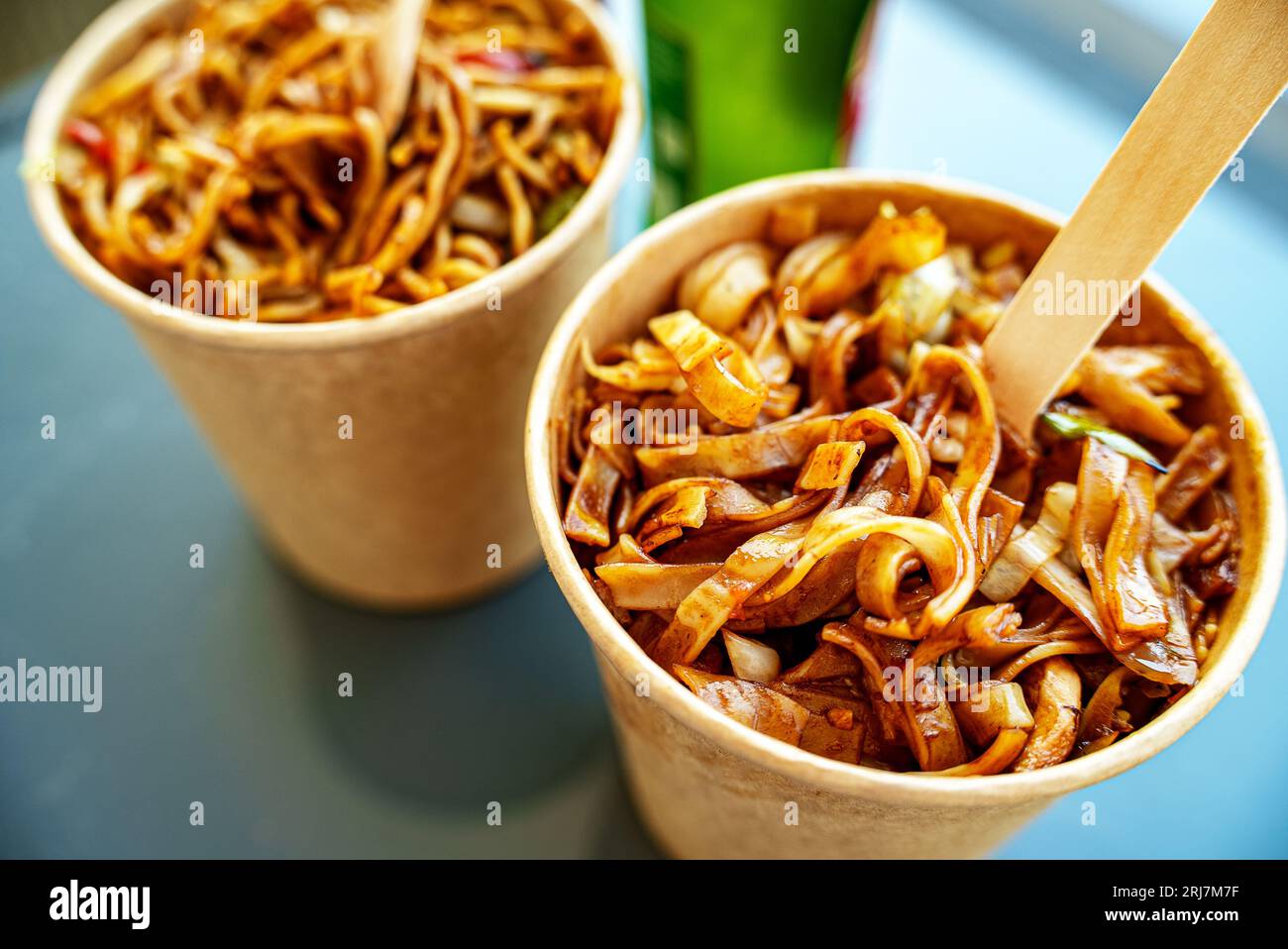 Chinese takeaway food. Wok with noodles and bottles with cold beer ...