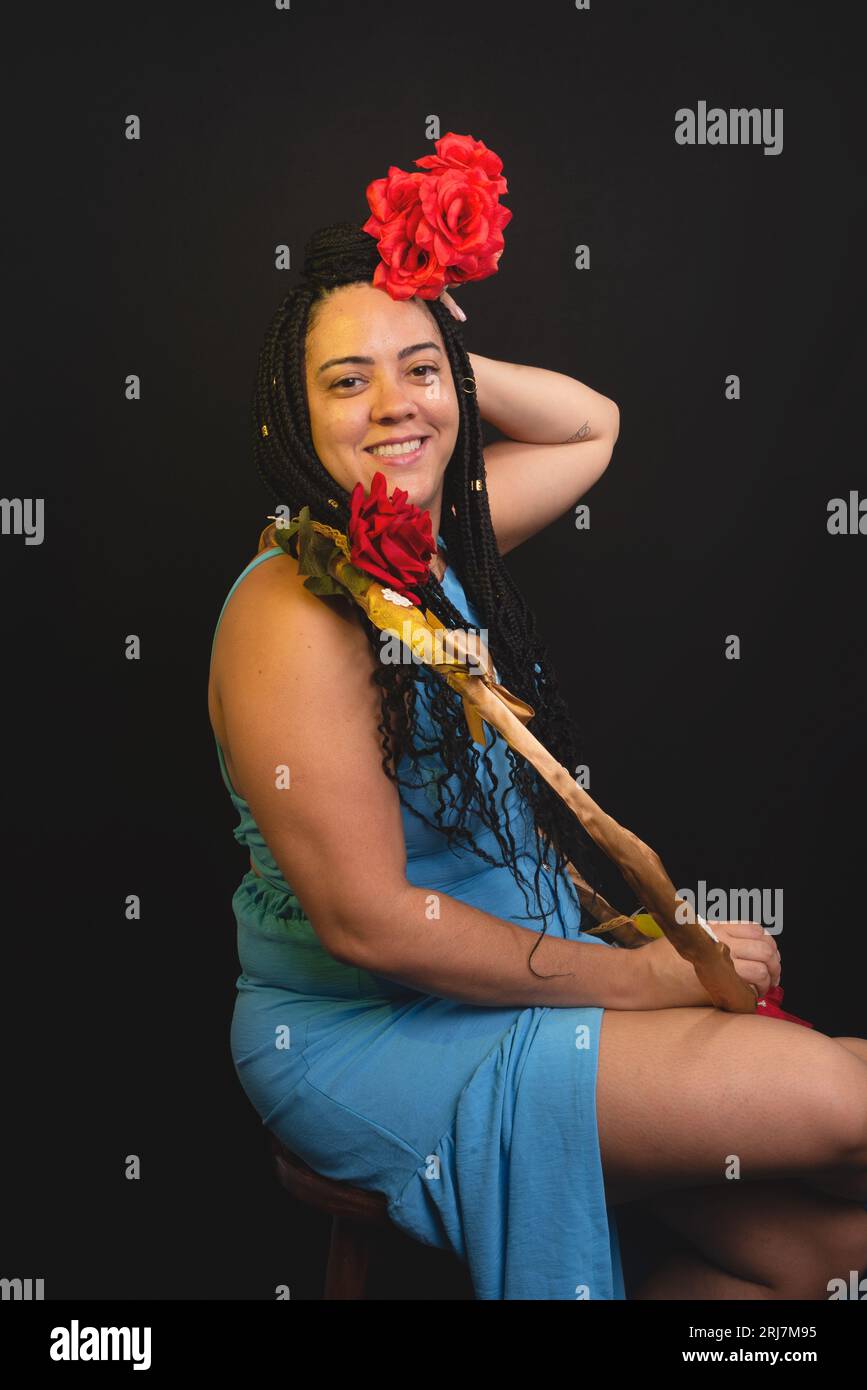 Beautiful woman with braids in her hair holding a hula hoop and placing ...