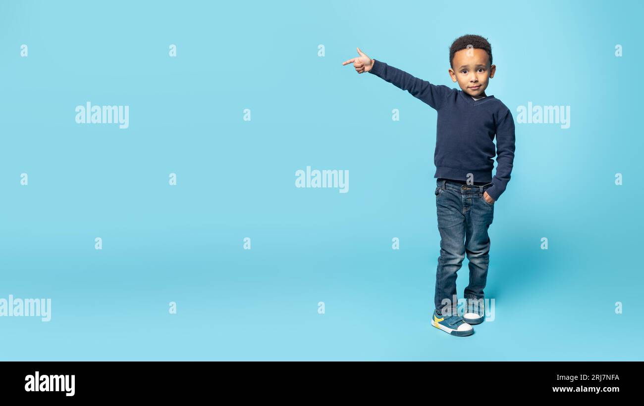 Nice offer. Glad black little boy pointing aside at copy space ...