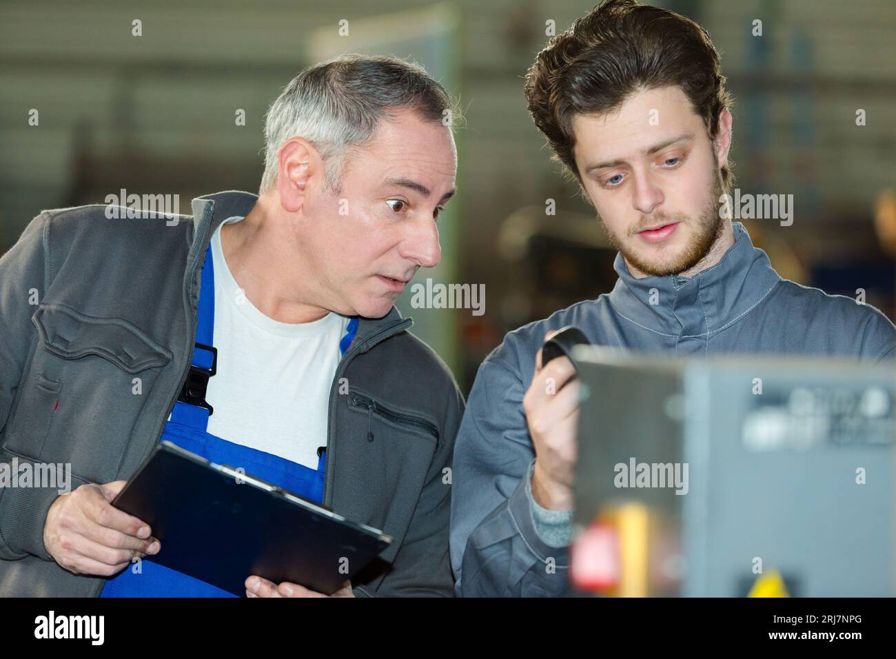 young hardware assembler being supervised Stock Photo - Alamy
