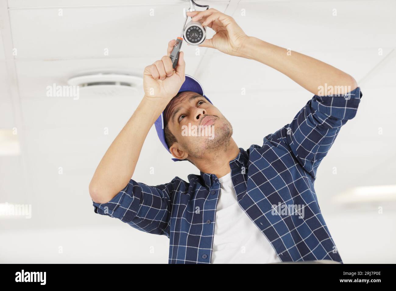 Handsome technician installing camera hi-res stock photography and ...