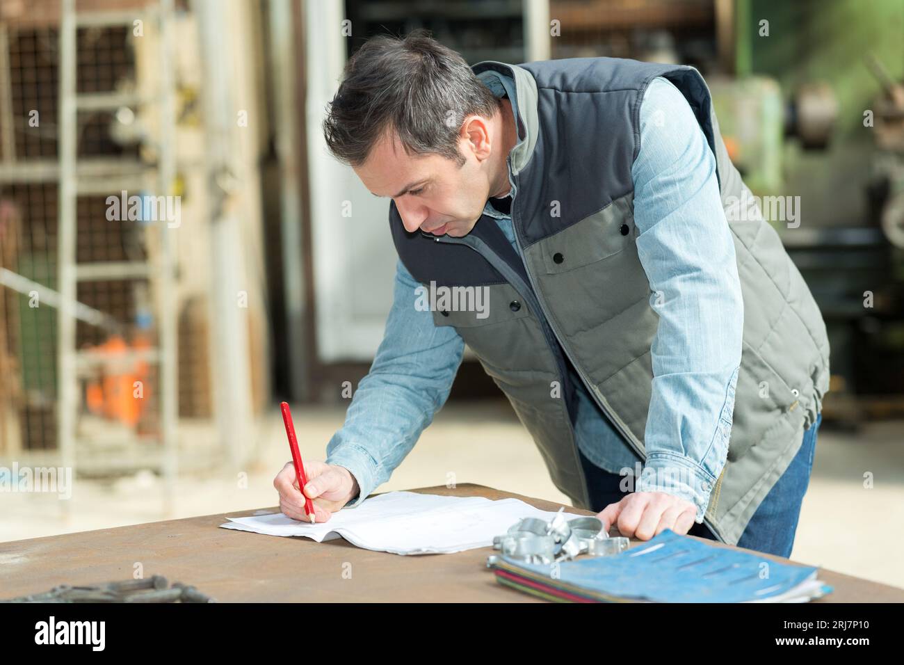 engineer writing notes on factory Stock Photo - Alamy