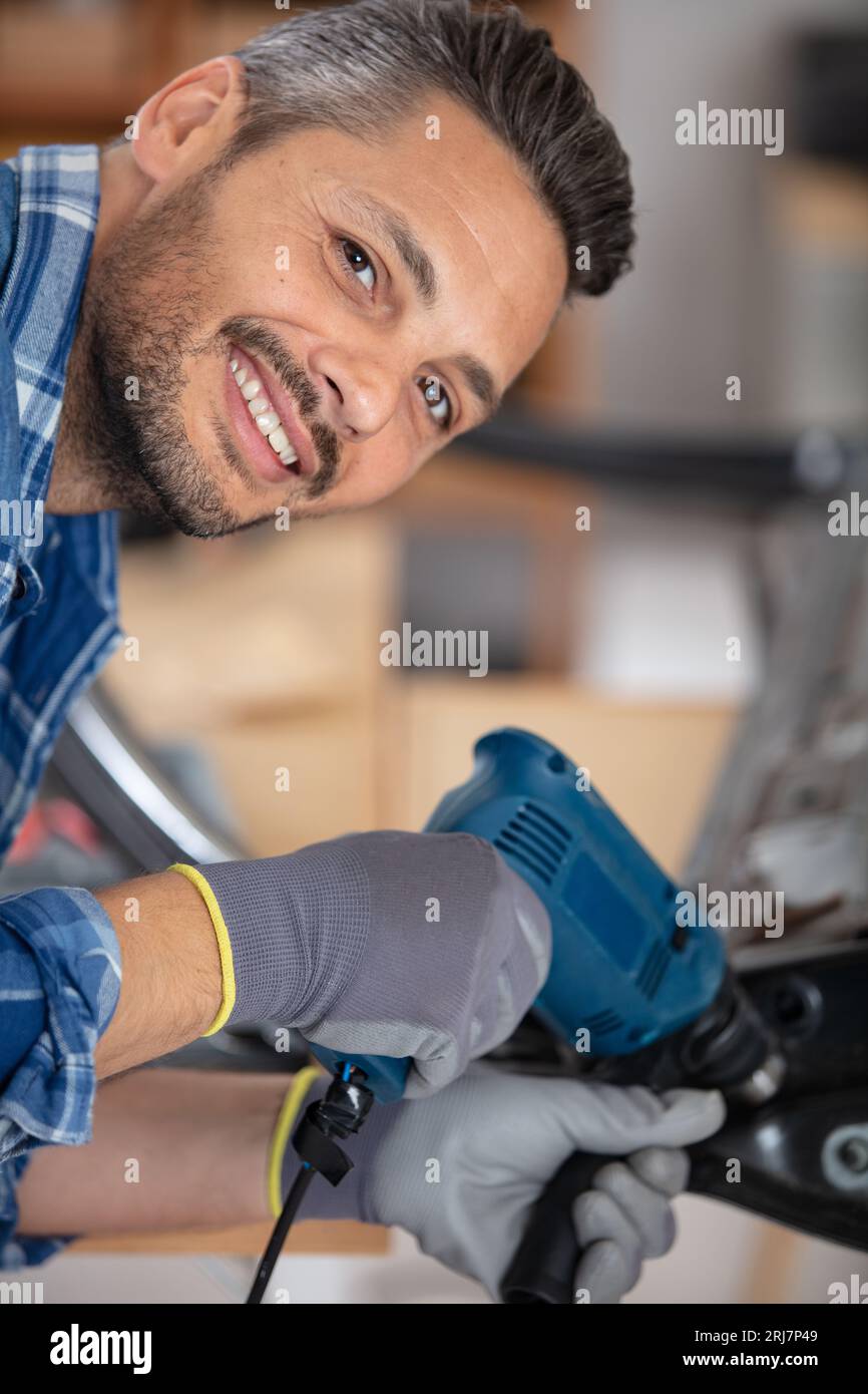 craftsman screws up bolts with a power tool Stock Photo - Alamy