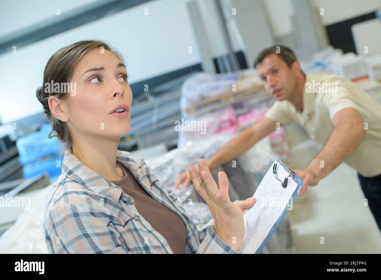 man completing paperwork in warehouse Stock Photo - Alamy