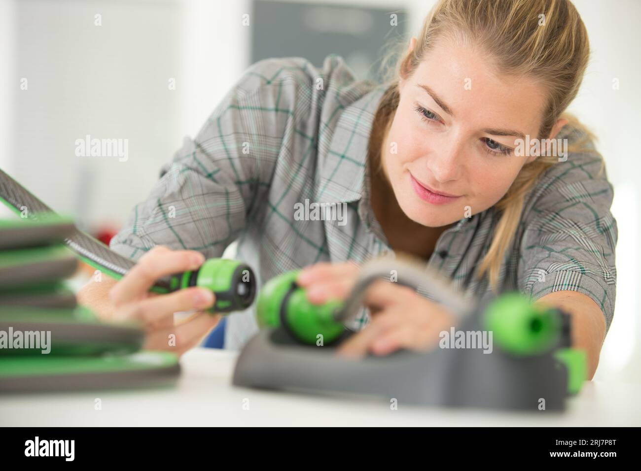 a female plumber connecting pipes Stock Photo - Alamy