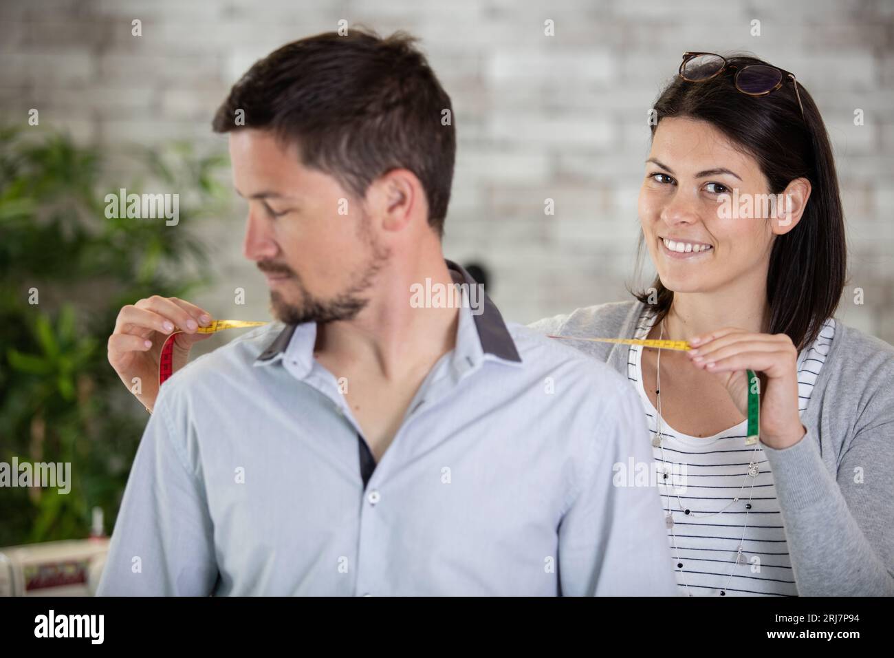 Tailor taking measures measuring tape hi-res stock photography and ...