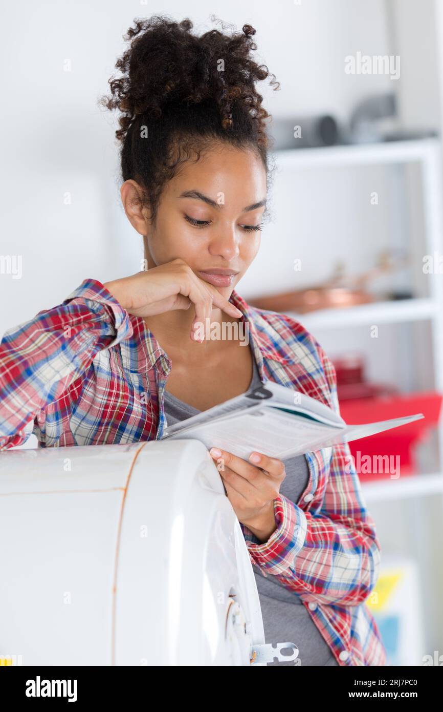 a woman reading a manual Stock Photo - Alamy