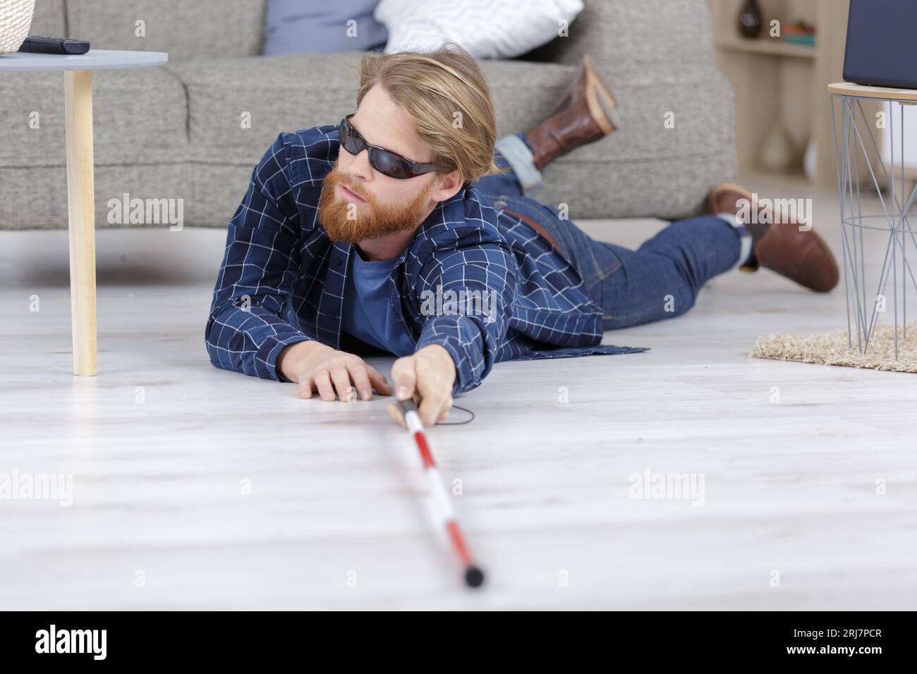 blind man with cane fallen over on to the floor Stock Photo - Alamy