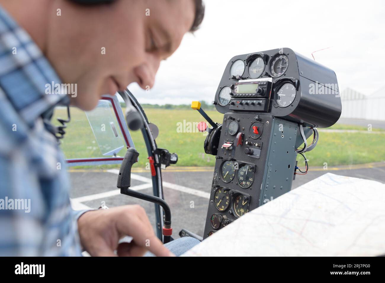 male aero engineer with clipboard working in helicopter cockpit Stock ...
