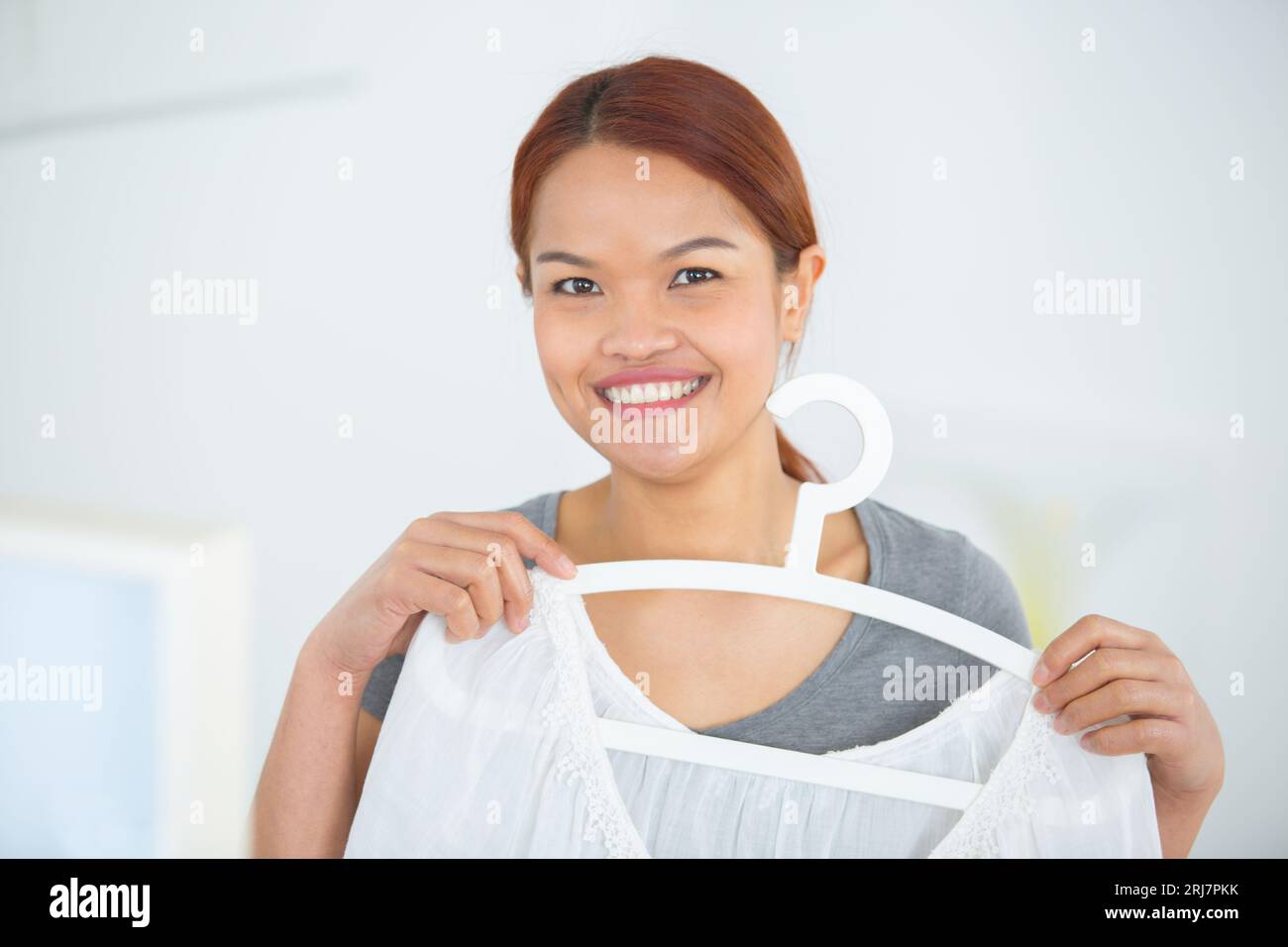 Asian woman trying on blouse hi-res stock photography and images - Alamy