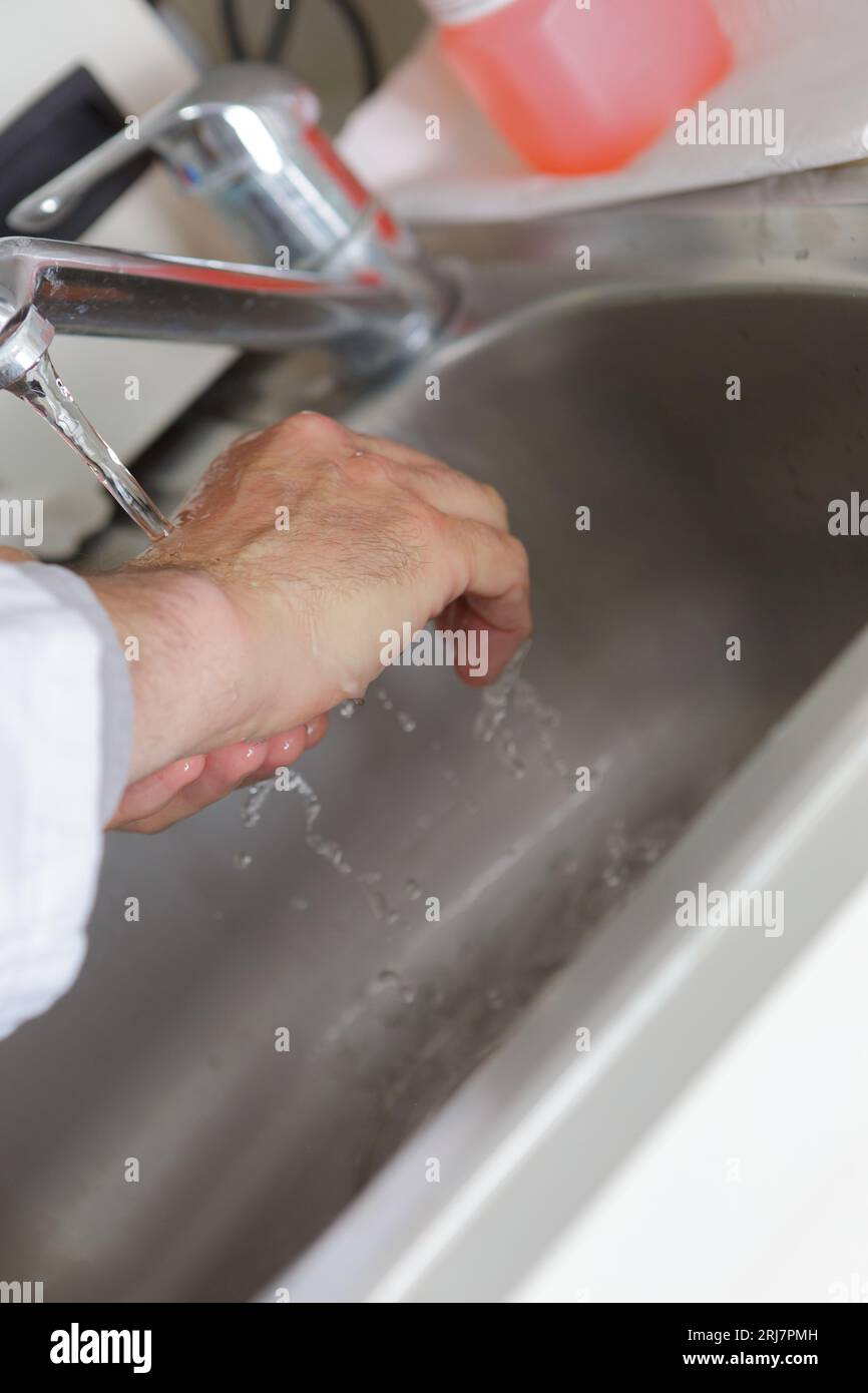 Male doctor washing hands hi-res stock photography and images - Alamy