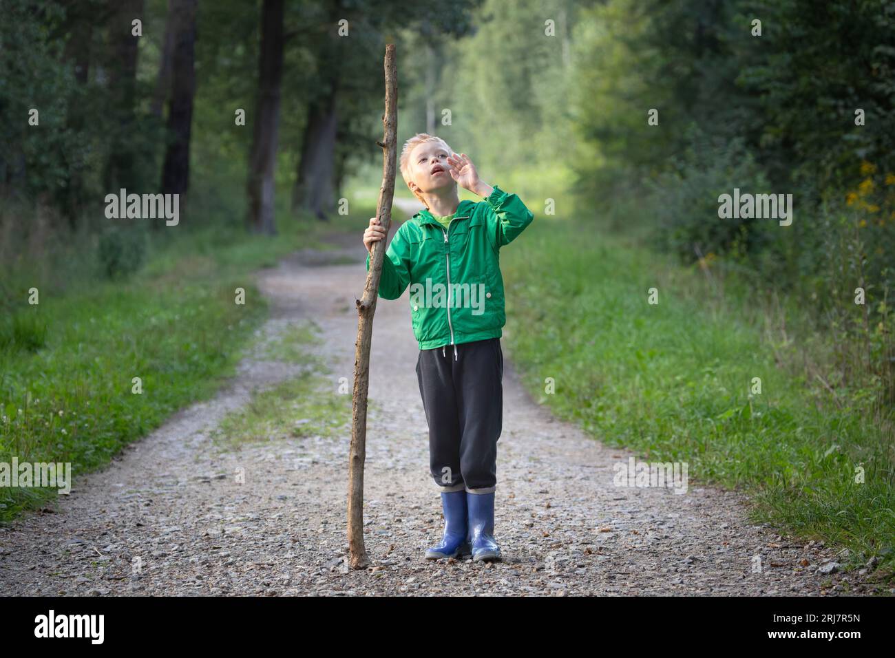 A seven-year-old boy is lost in the forest and calls for help Stock ...