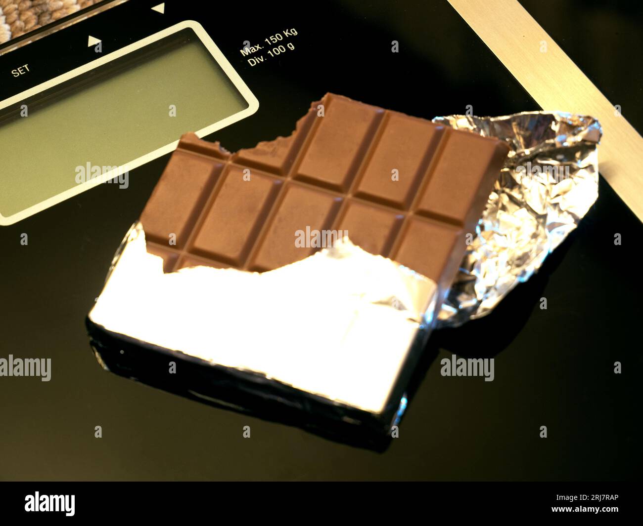 chocolate bar on a electronic scale, conceptual photo Stock Photo - Alamy