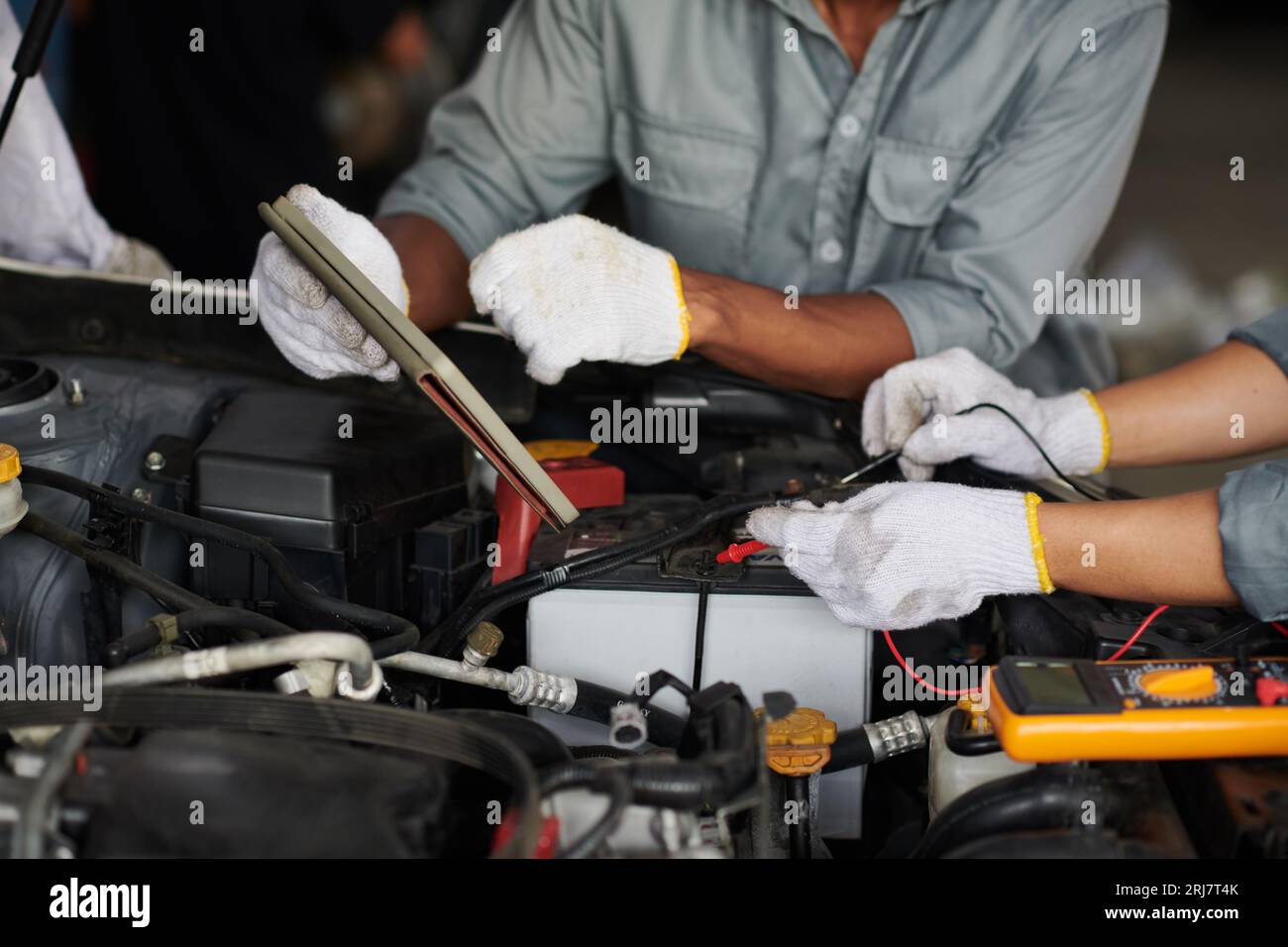 Car mechanics using digital endoscope and tablet computer when ...