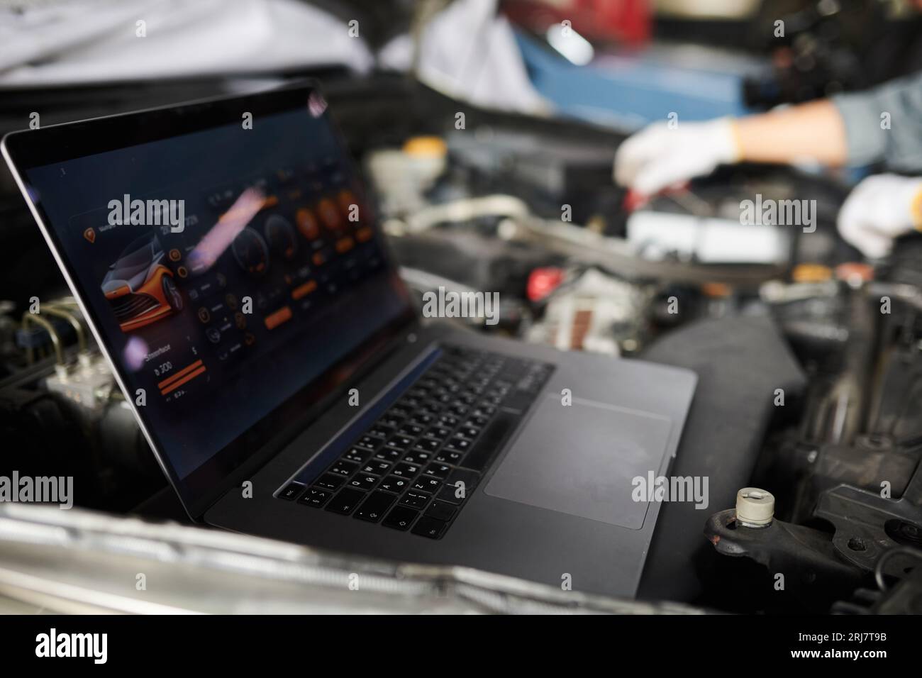 Mechanics using program on laptop when analyzing car computer systems ...
