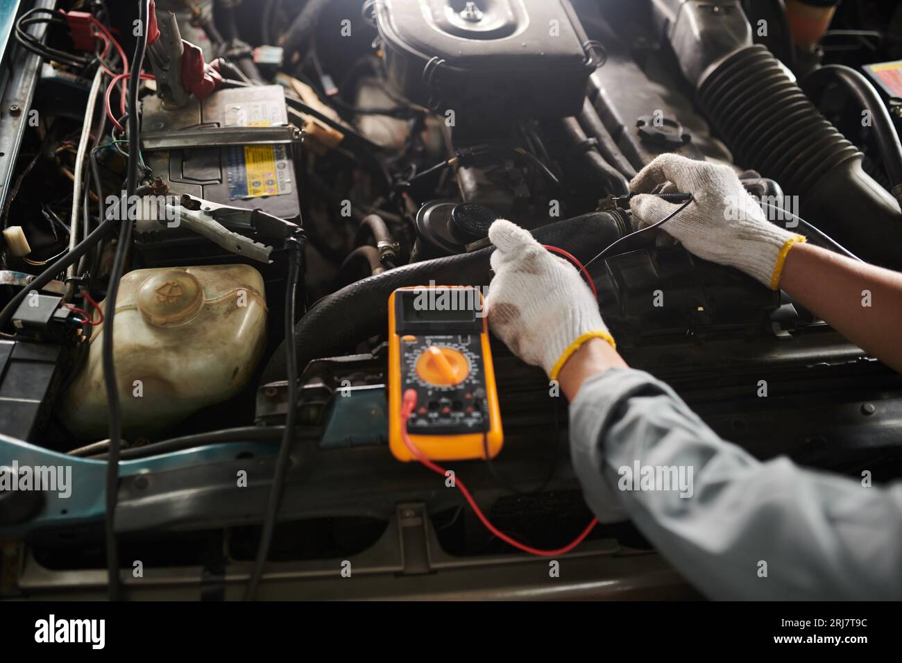Car service worker using multimeter when checking car engine Stock ...
