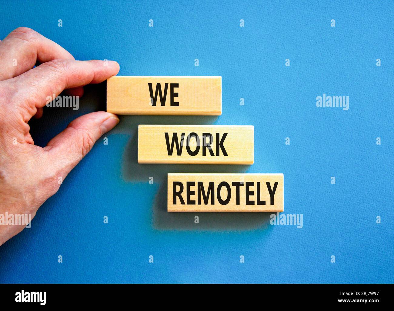 We work remotely symbol. Concept words We work remotely on wooden block ...