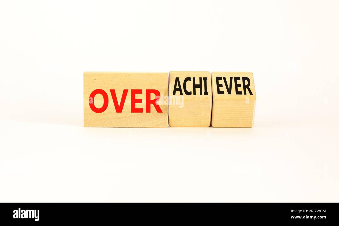 Achiever or overachiever symbol. Businessman turns wooden cubes and ...