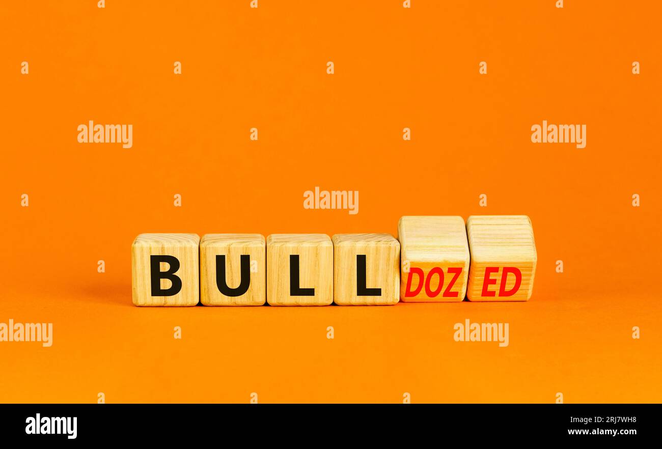 Bull or bulldozed symbol. Businessman turns wooden cubes and changes ...