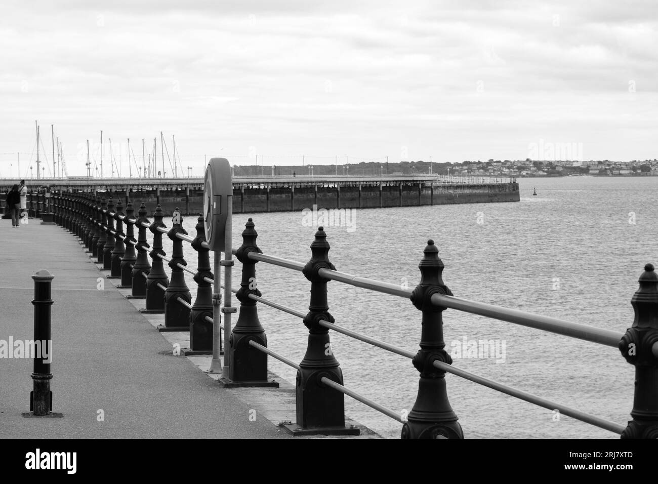 A black and white image of a section of the long seafront at Torquay ...