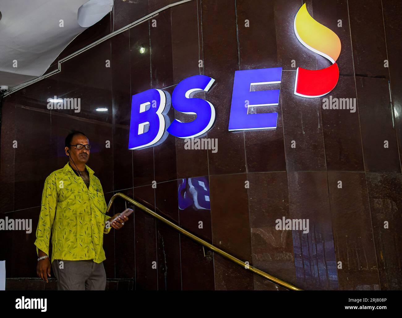 Mumbai, India. 21st Aug, 2023. A man walks past a new Bombay Stock ...