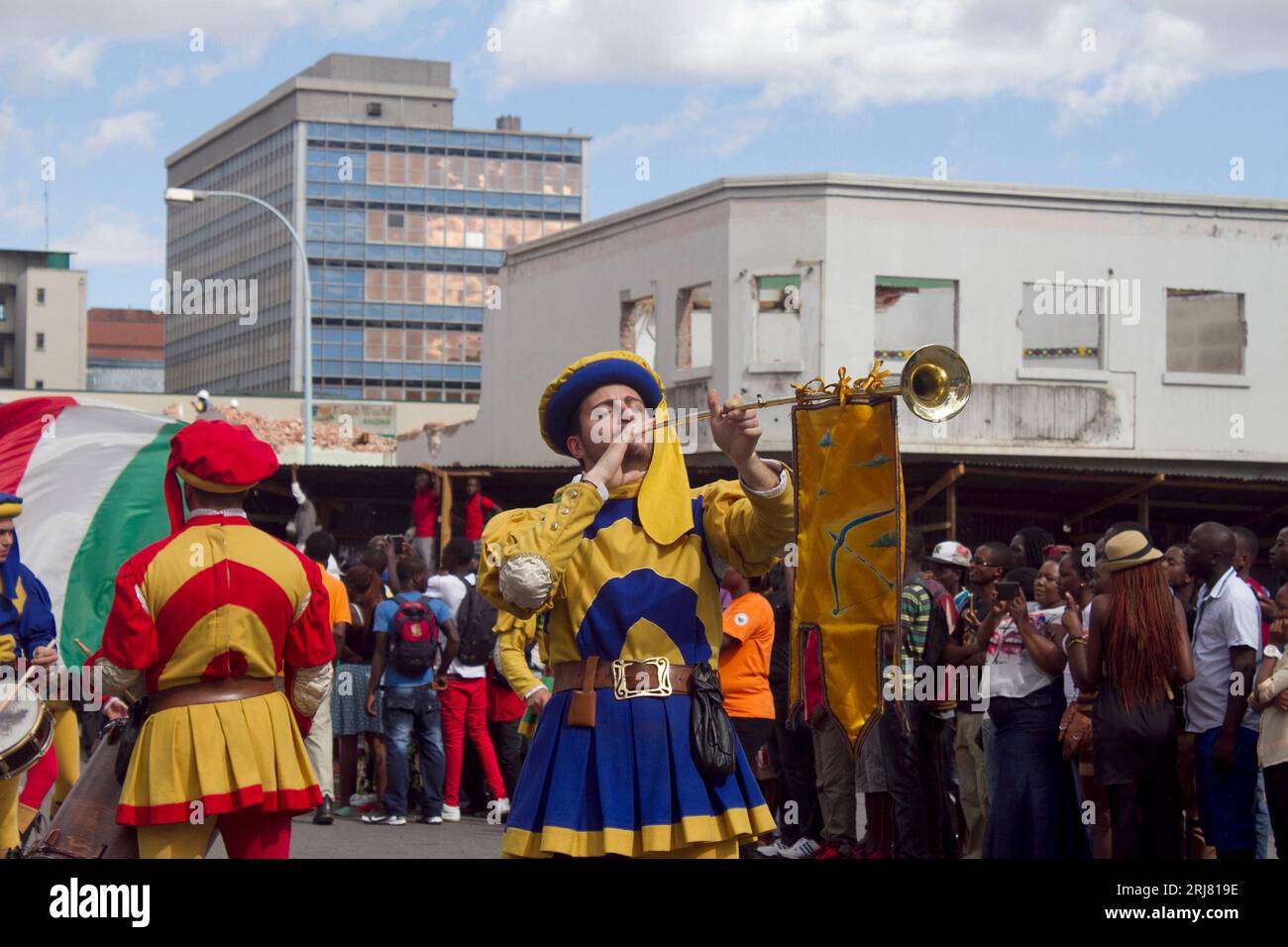 A perfomer is seen blowing a trumpet during a street carnival parade on ...