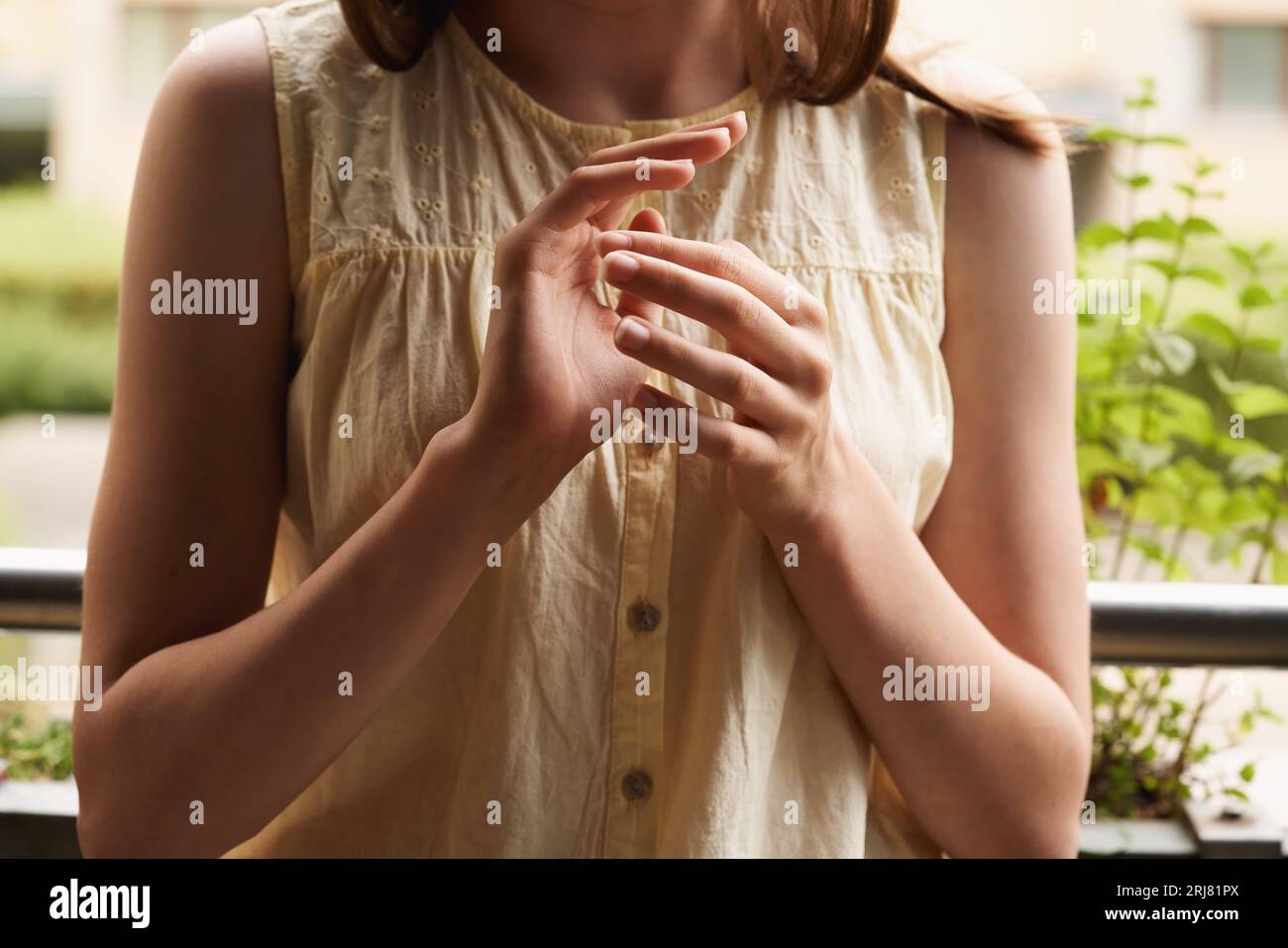 Teenage girl tapping on the side of the hand - practicing EFT or ...