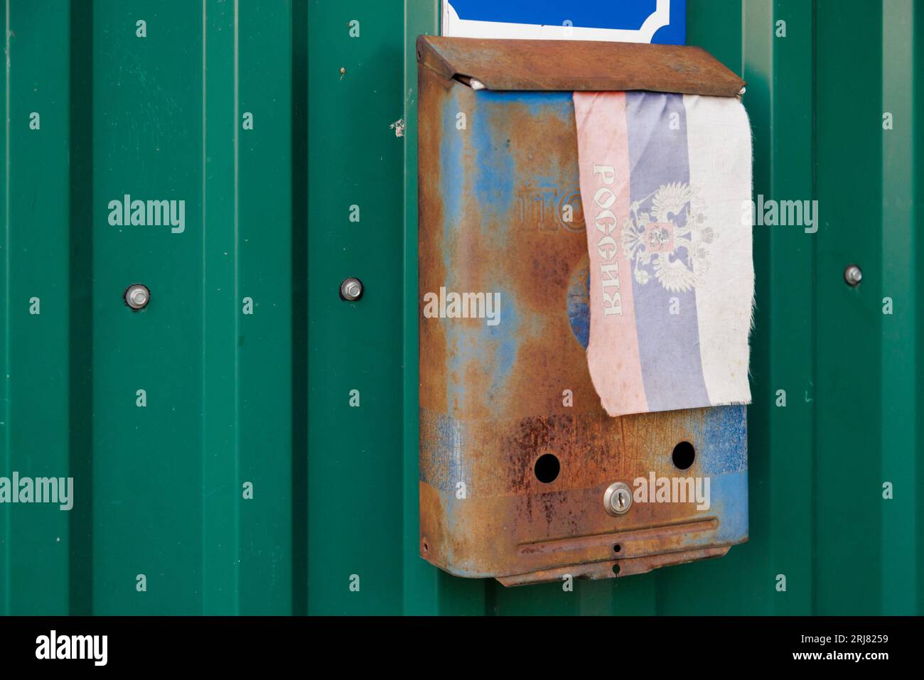 old rusty russian mailbox on the wall with extremely faded small fabric ...