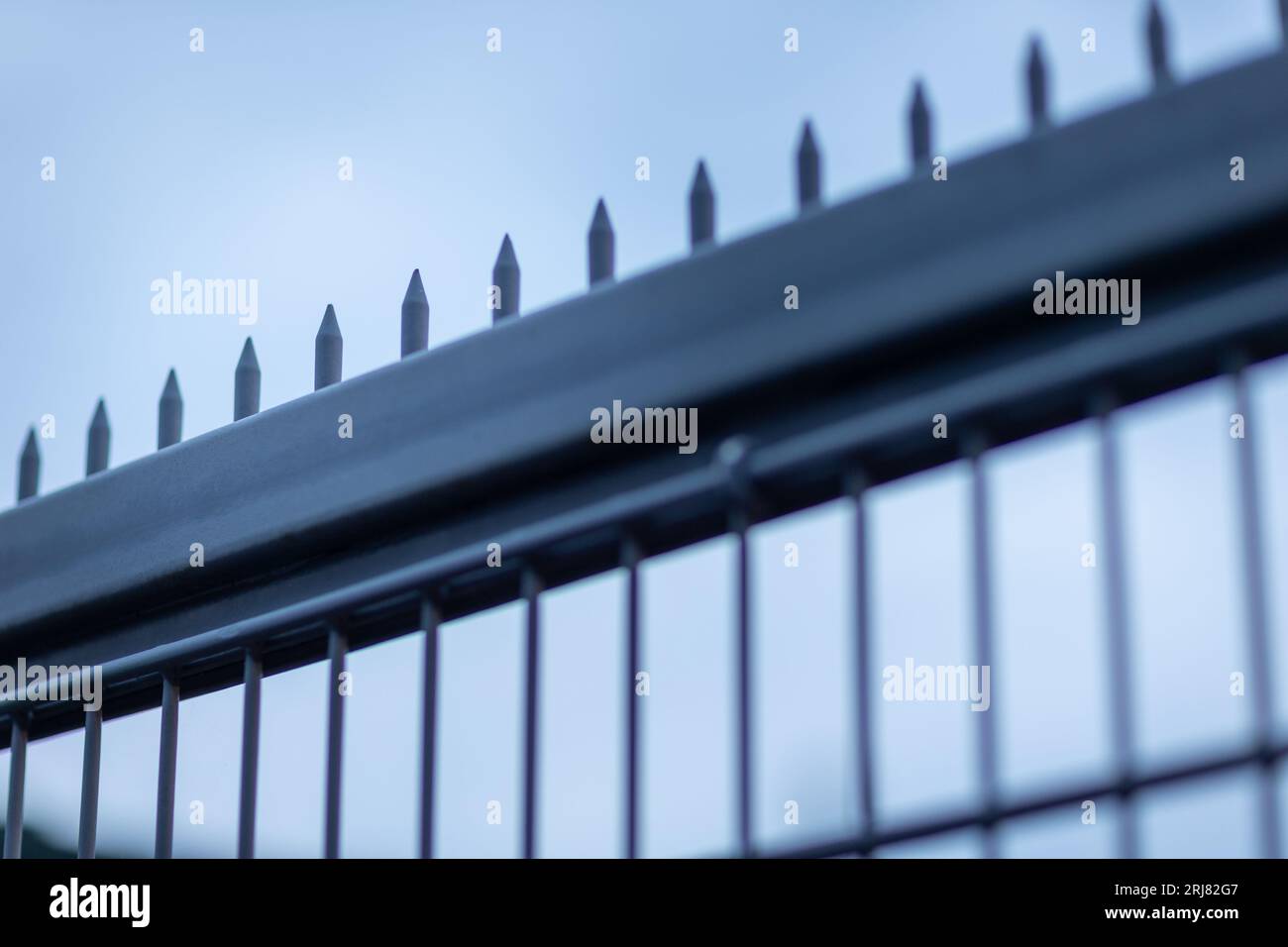 Security fence with small sharp spikes, guarding highend luxury ...