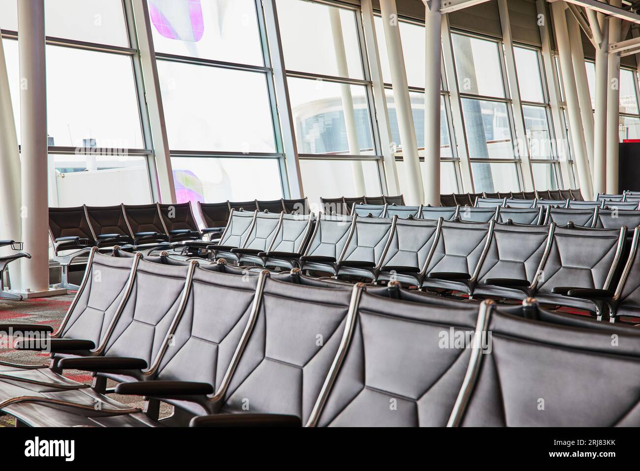 Generic view of empty airport seats at terminal with blown out windows ...