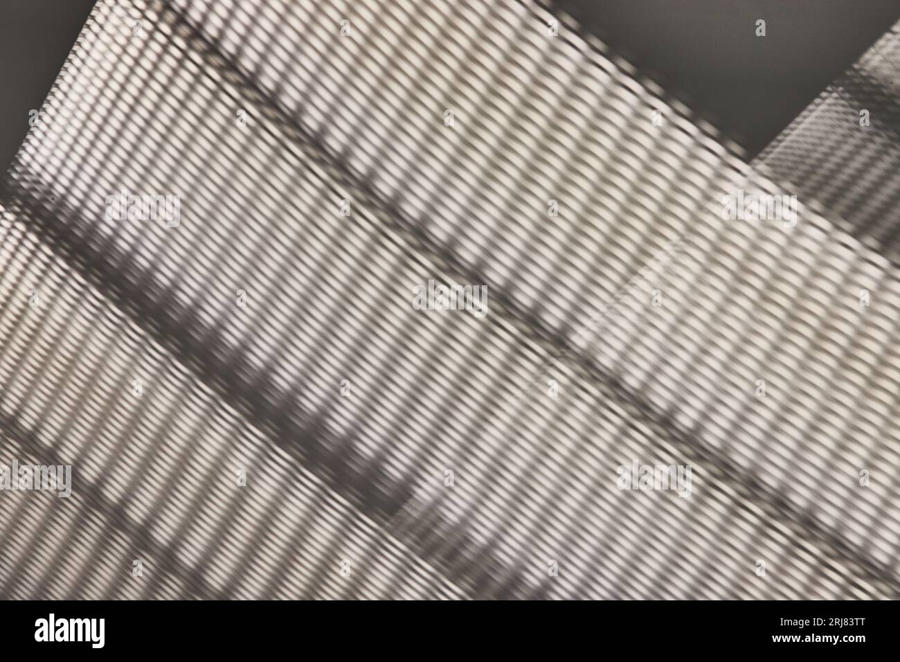 Light poking through woven type material creating abstract art in ...