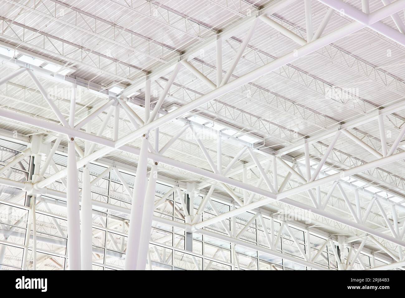 Pristine white walls and ceiling with metal support beams and trussed ...
