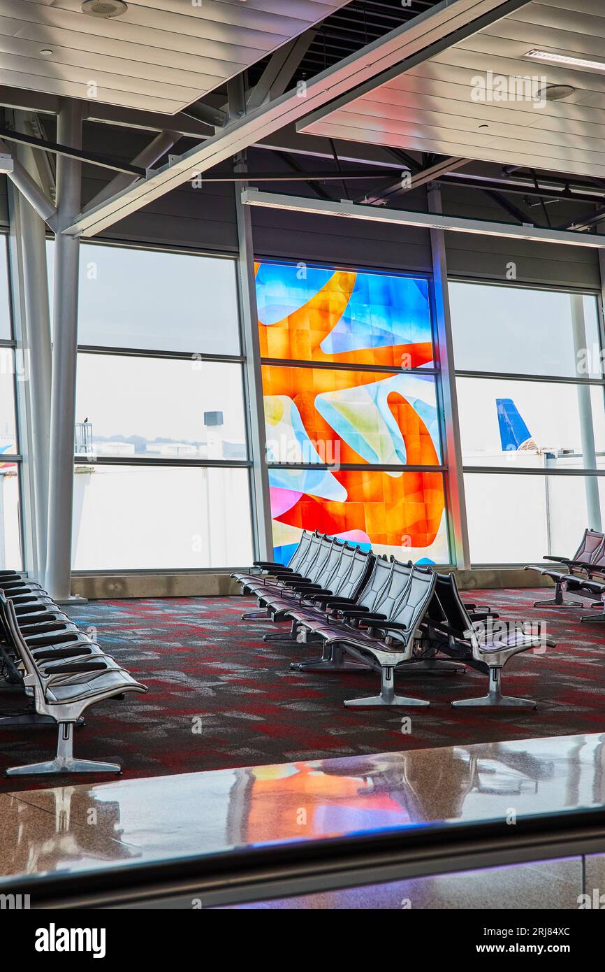 Abstract vibrant window art in empty airport terminal with seats Stock ...