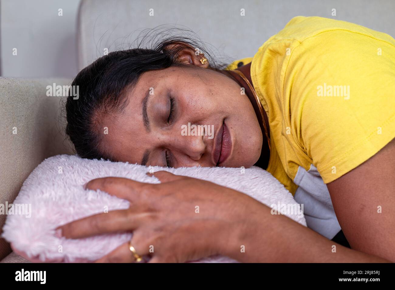 A beautiful woman with long, flowing hair smiles contentedly as she ...