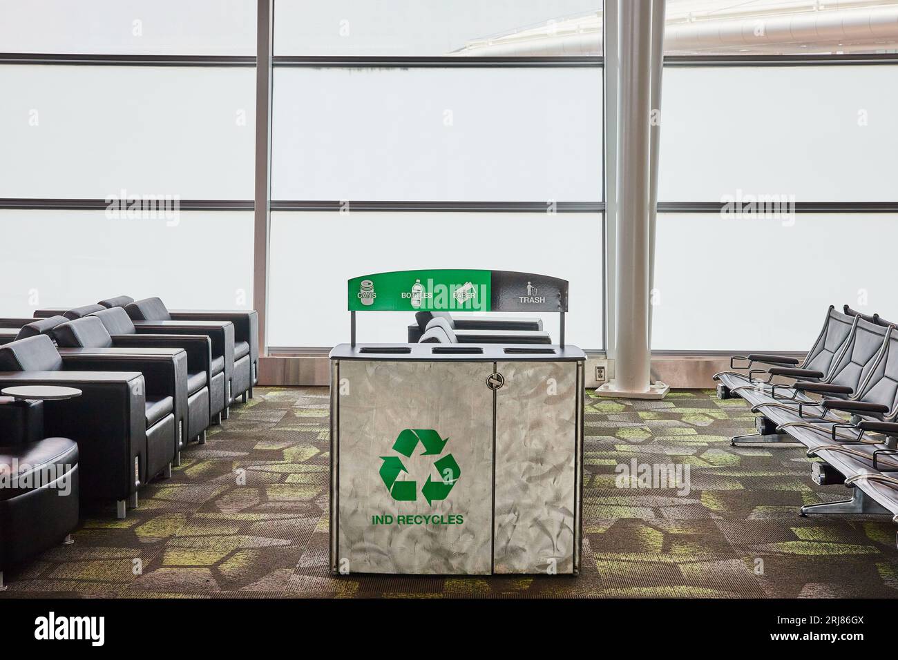 Ind Recycles recycling receptacle in empty airport terminal with chairs ...