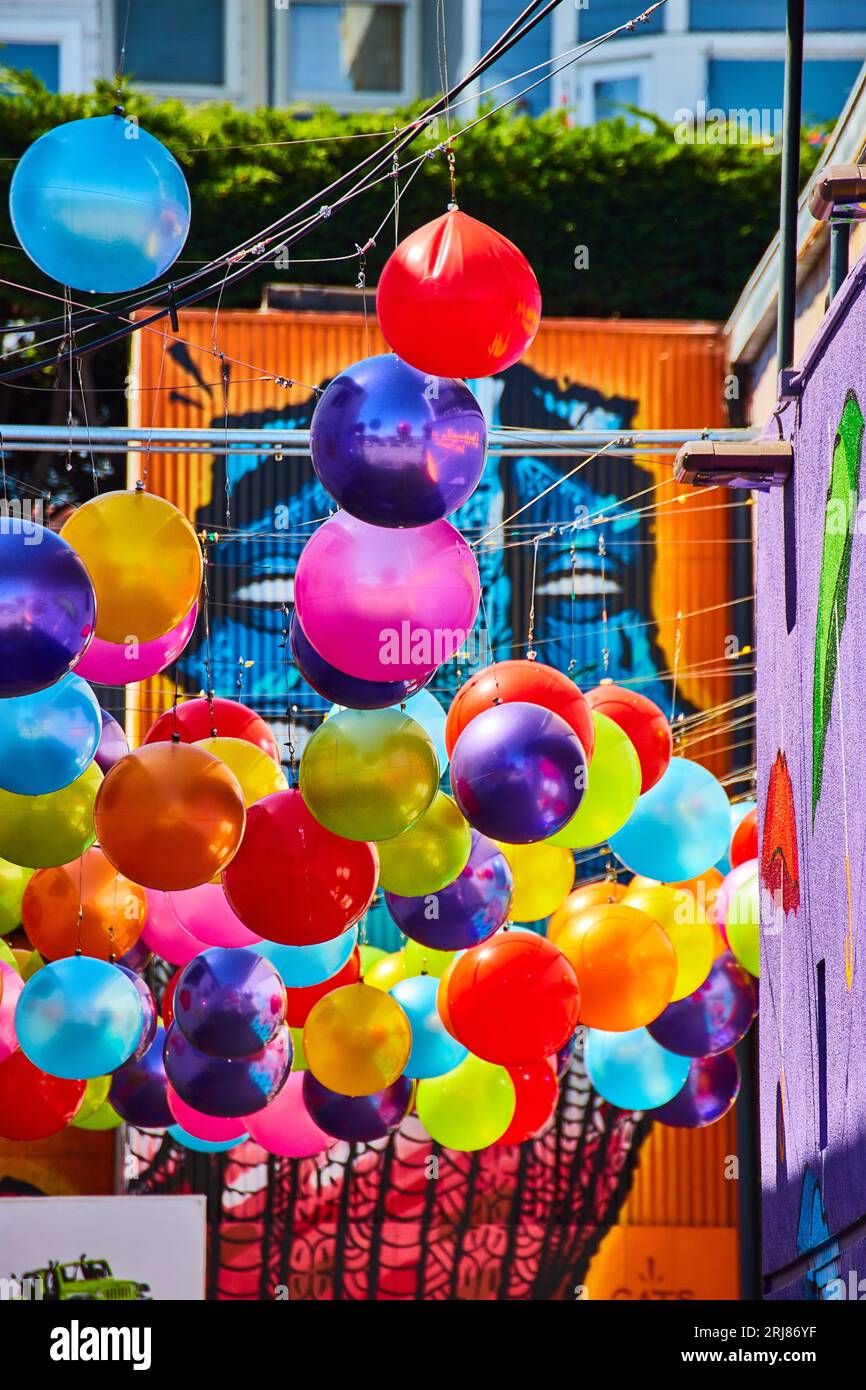 Vibrant and colorful hanging balloon balls with mural art Stock Photo ...