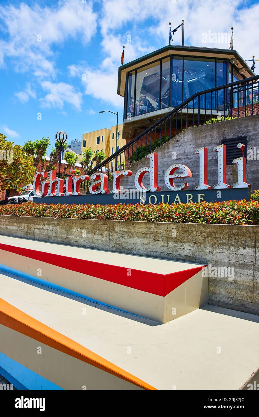 Ghirardelli Square sign with colorful concrete seating and shrubbery ...