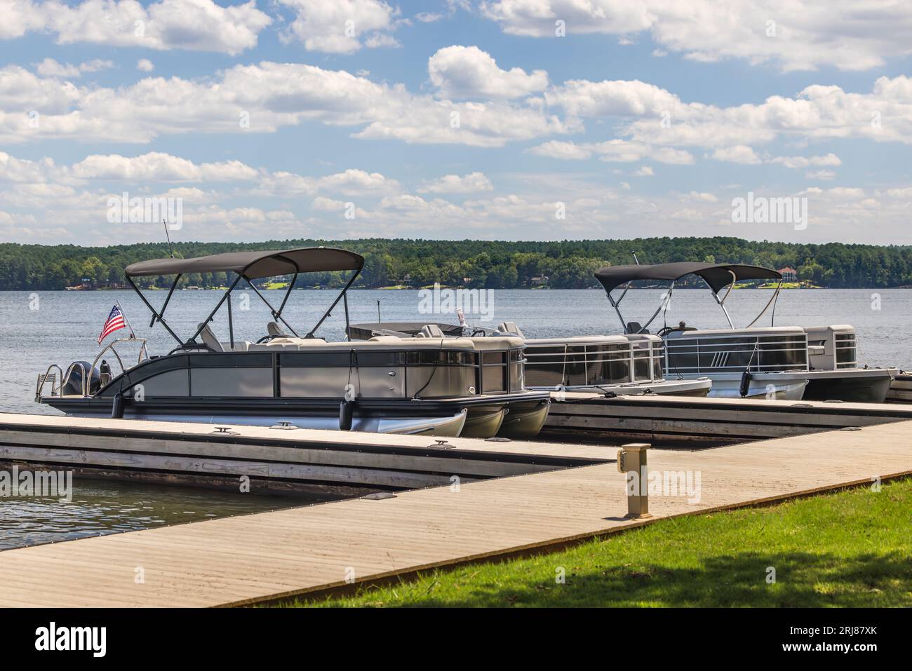 Multiple pontoon boats at marina dock on freshwater lake Stock Photo ...