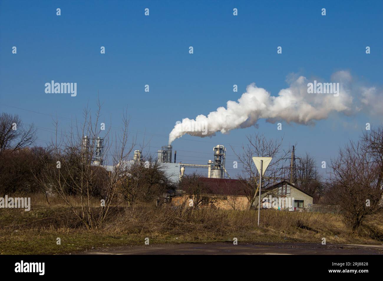 The plant emits smoke and smog from the pipes at mist cloudy ...